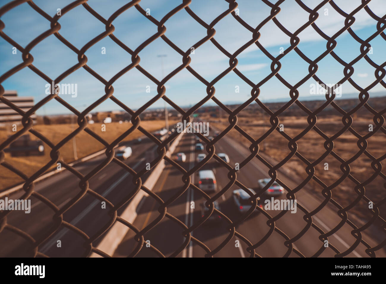 Highway view through fence Stock Photo - Alamy