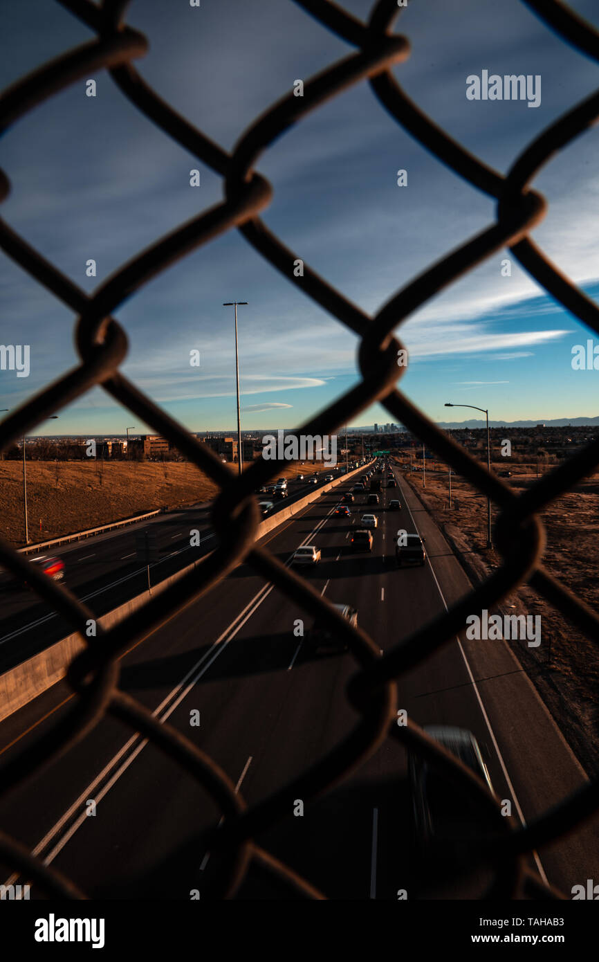 Highway view through fence Stock Photo - Alamy
