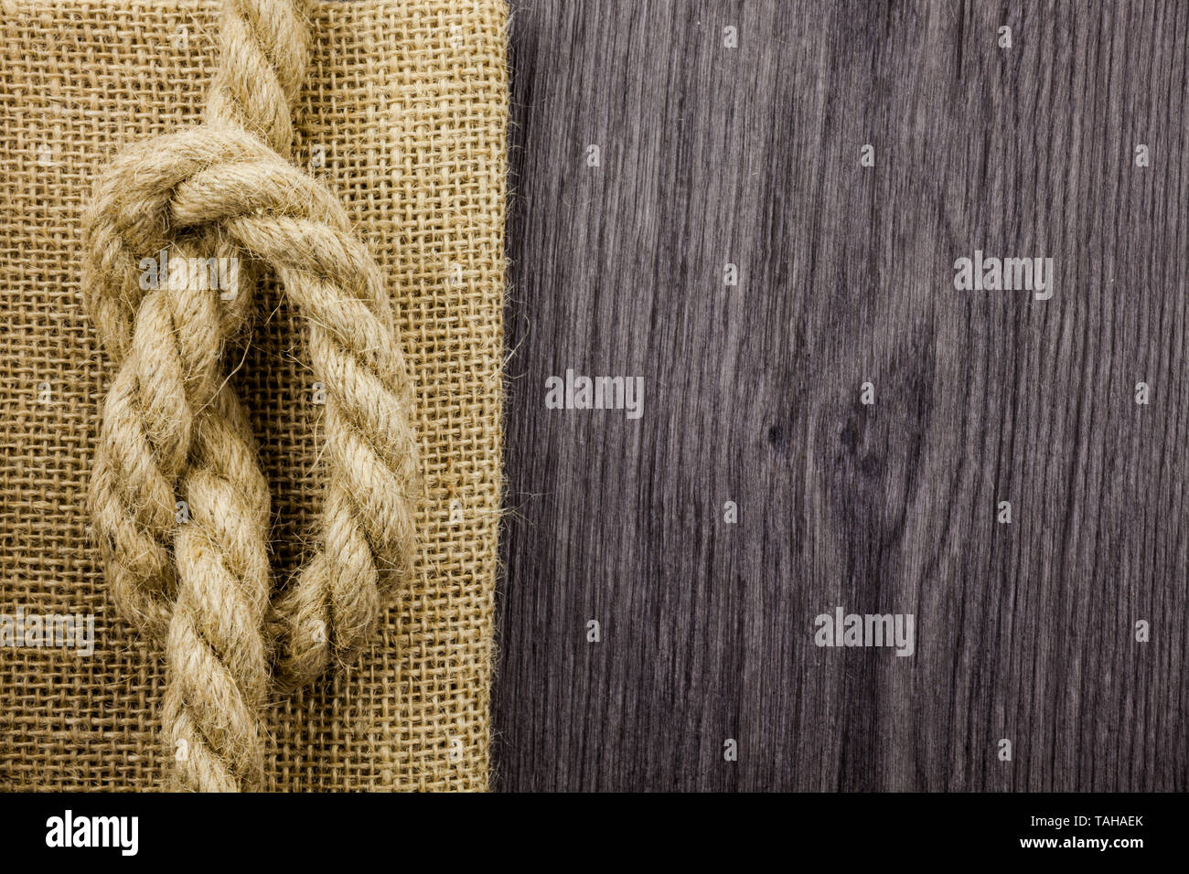 Front view half wooden background right side jute robe knot left side ...