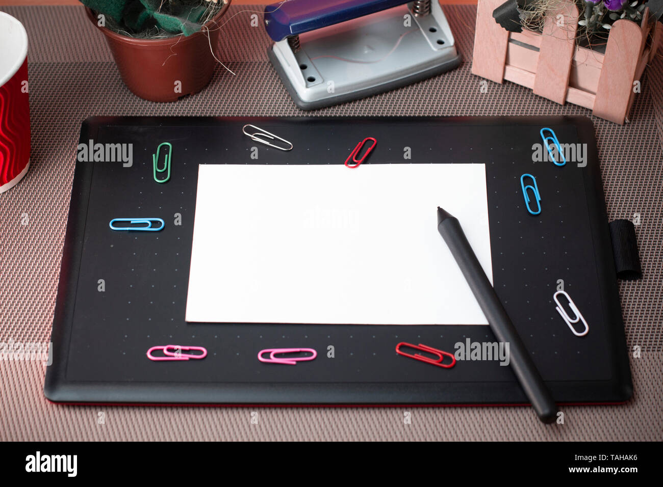 Scissors and writing equipments plus math book above textured backdrop ...