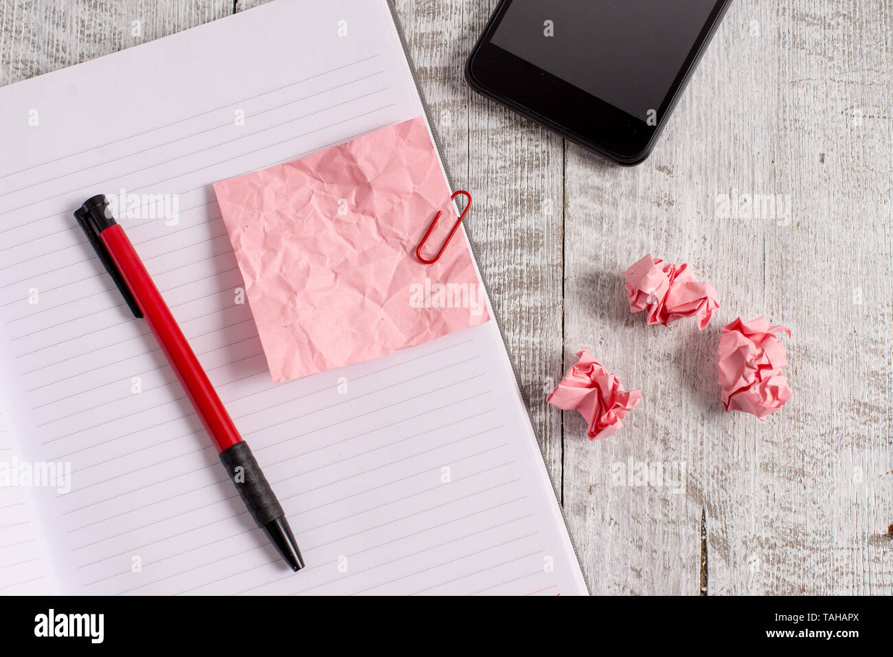 Wrinkle paper and notebook plus stationary placed above wooden ...