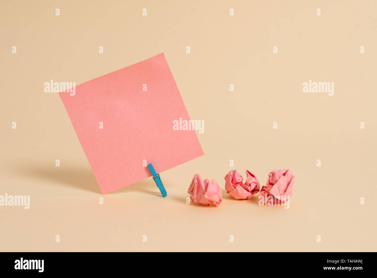 Plain note paper and stationary placed above soft pastel colour ...