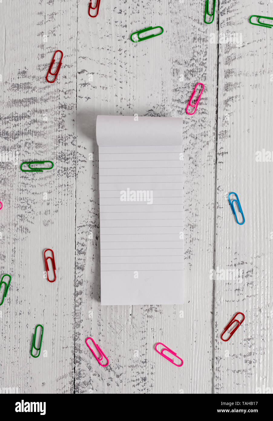 Stripped ruled notepad clips lying wooden old retro vintage background ...
