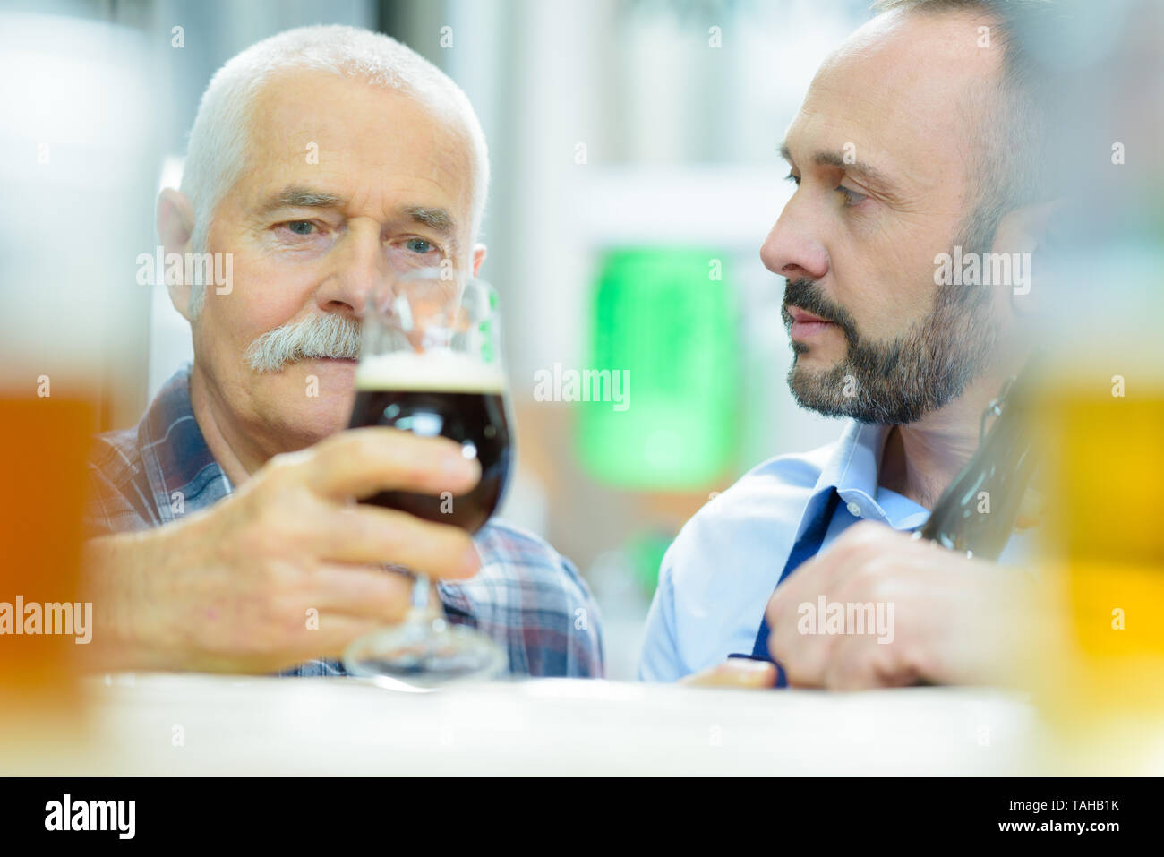 two men brewing beer in the craft microbrewery Stock Photo - Alamy