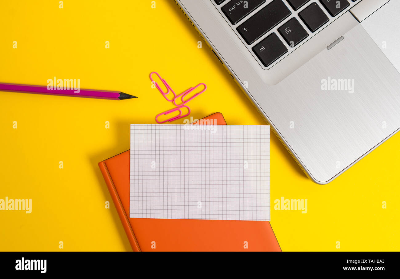 Laptop clips pencil paper sheet hard cover notebook colored background ...