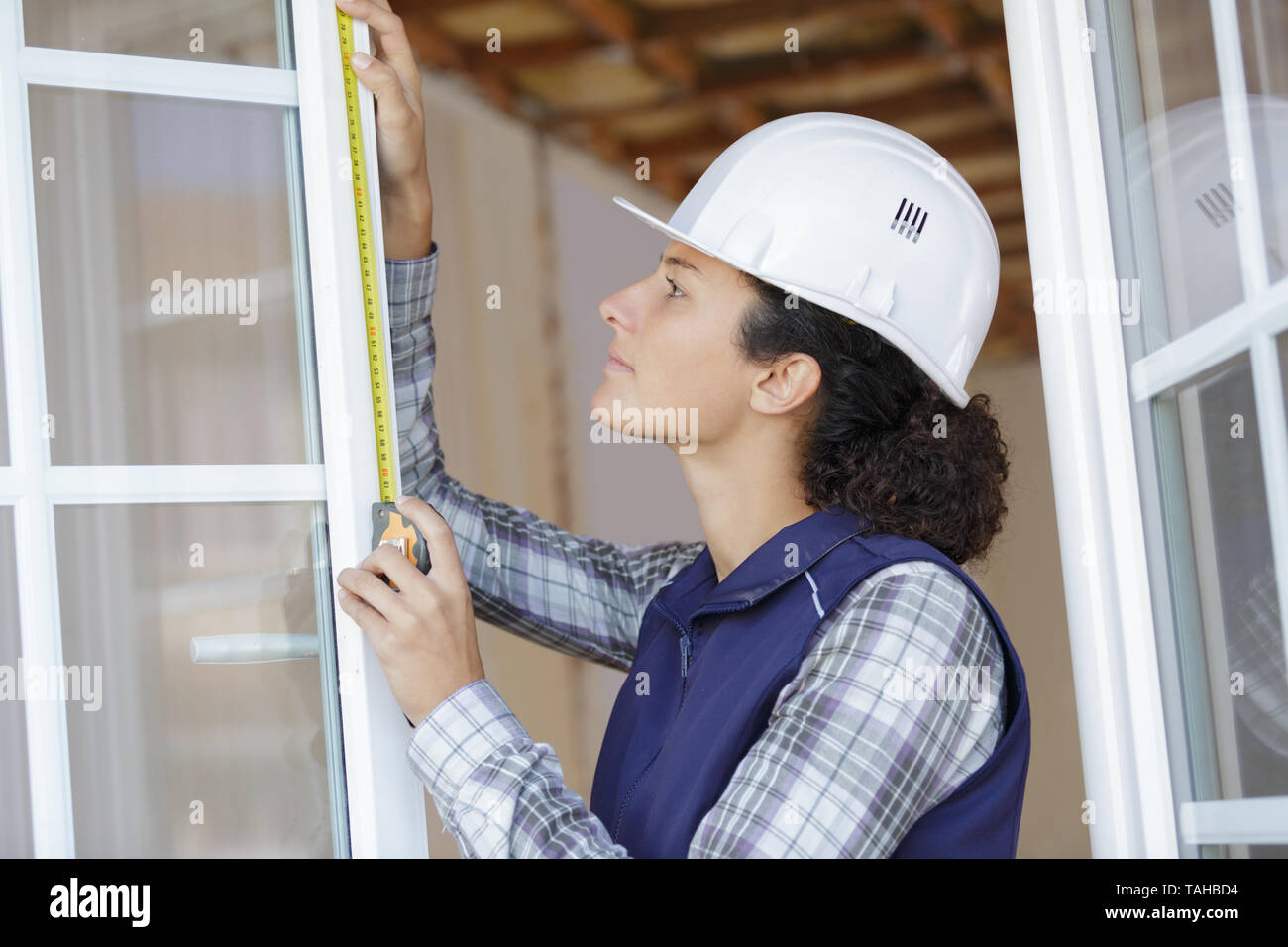 female worker measure the window Stock Photo - Alamy