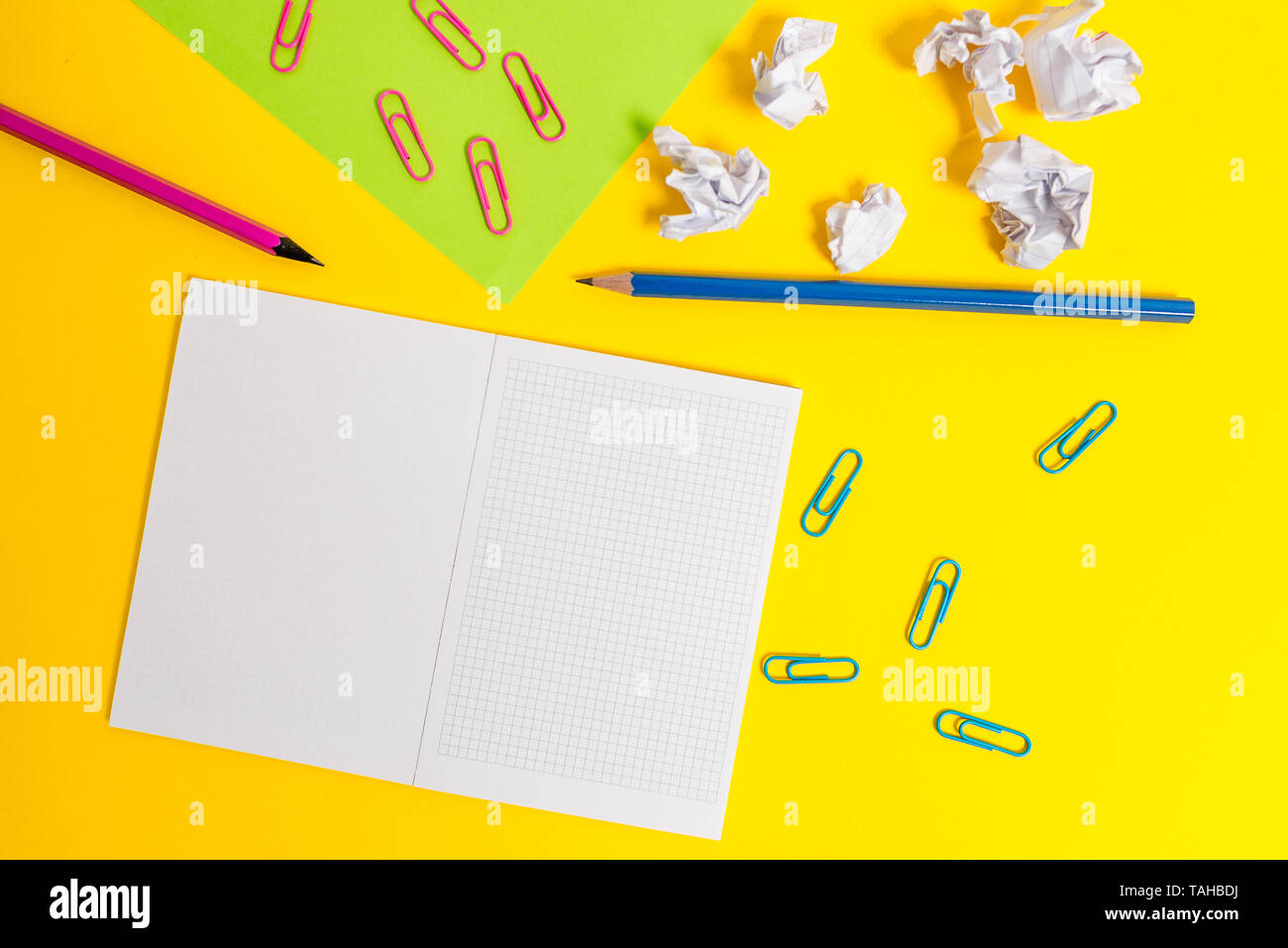 Blank squared notebook pencils paper sheet crushed balls colored ...