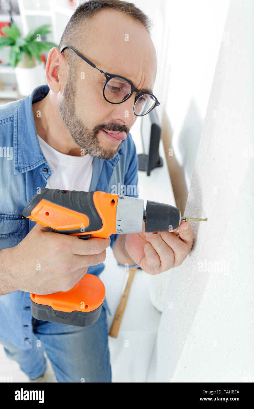 Handy man drilling hi-res stock photography and images - Alamy