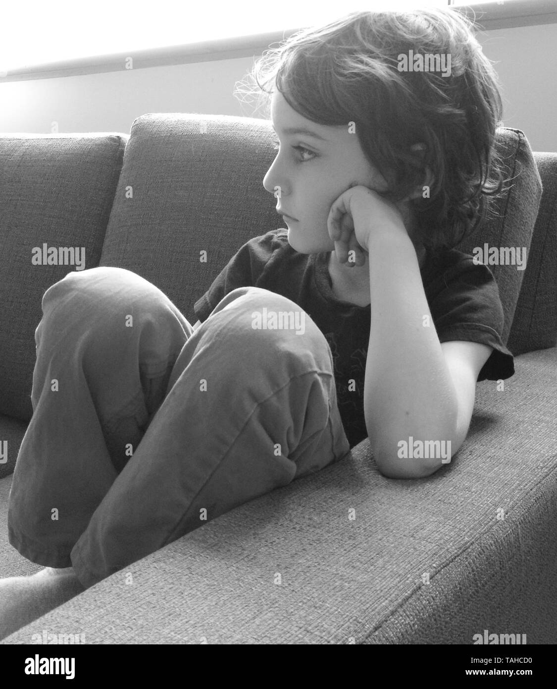 Child deep in thoughts Stock Photo - Alamy