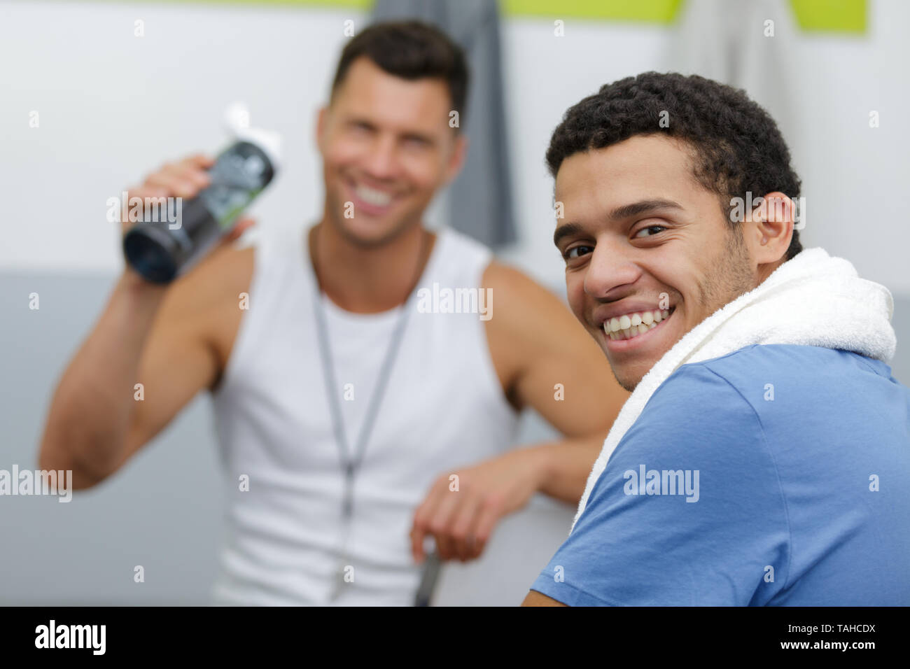 coach and player talking in changing room Stock Photo - Alamy