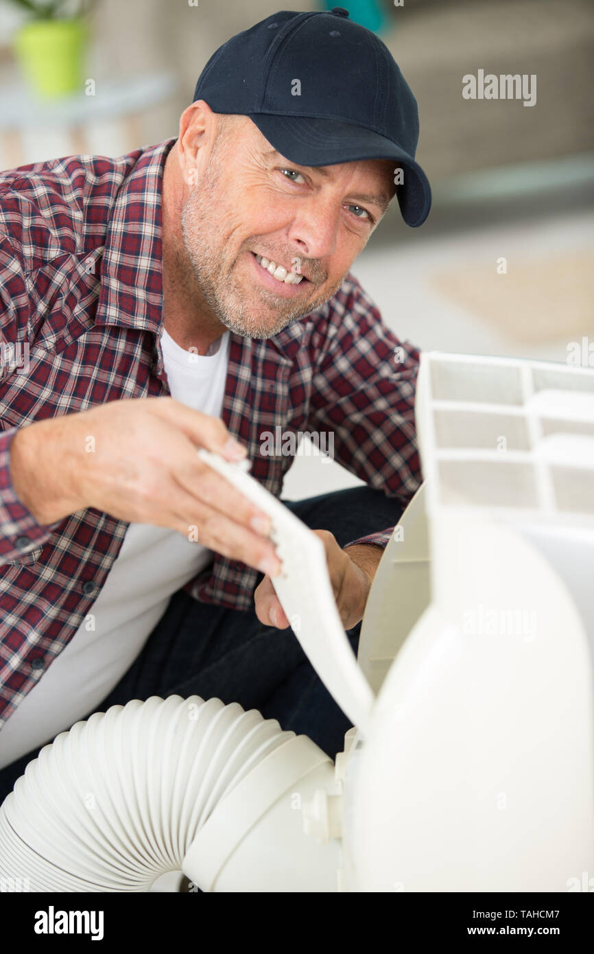 mature man fixing air conditioner at home Stock Photo - Alamy