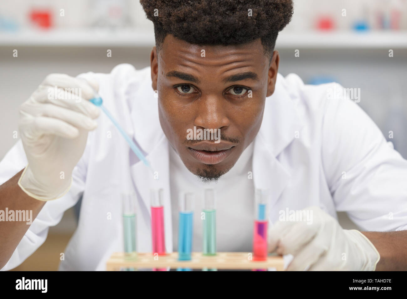 young chemist at work mixing liquids in lab Stock Photo - Alamy
