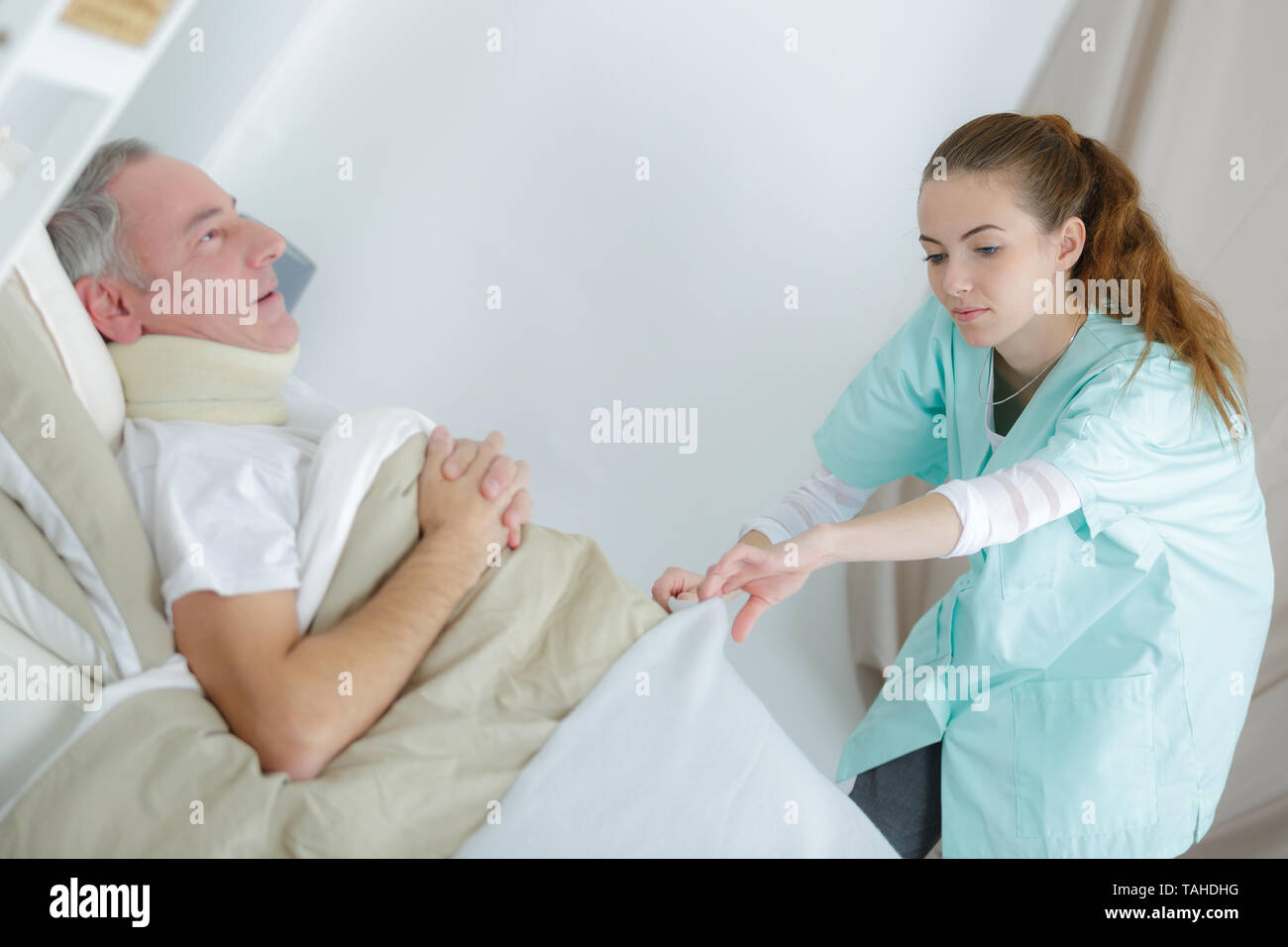 nurse taking care of bedridden man Stock Photo - Alamy
