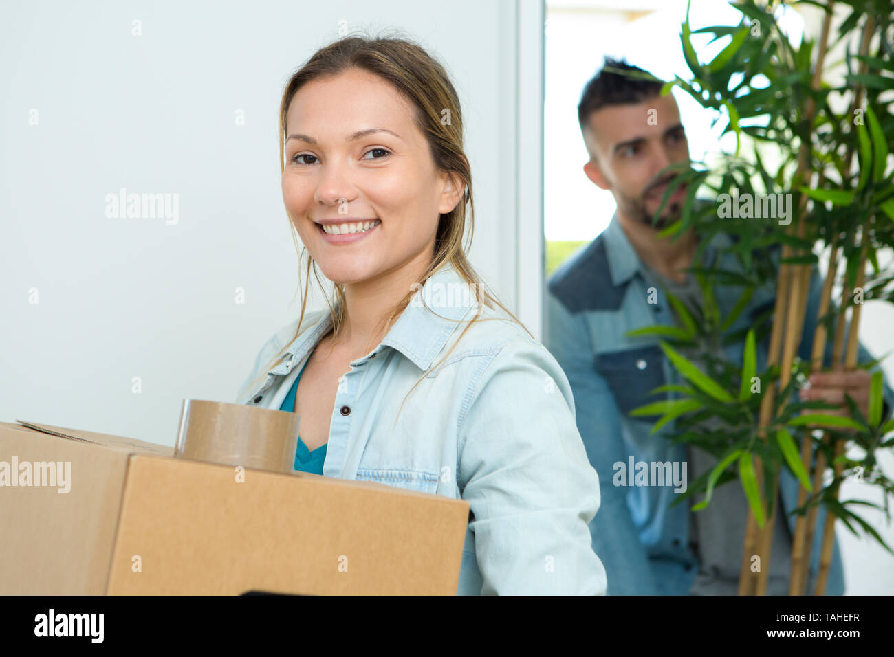happy woman moving in carrying cartons boxes Stock Photo - Alamy