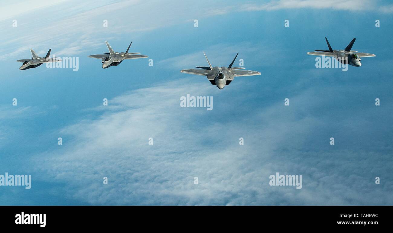U.S. Air Force F-22 Raptor stealth fighter aircraft fly in formation ...