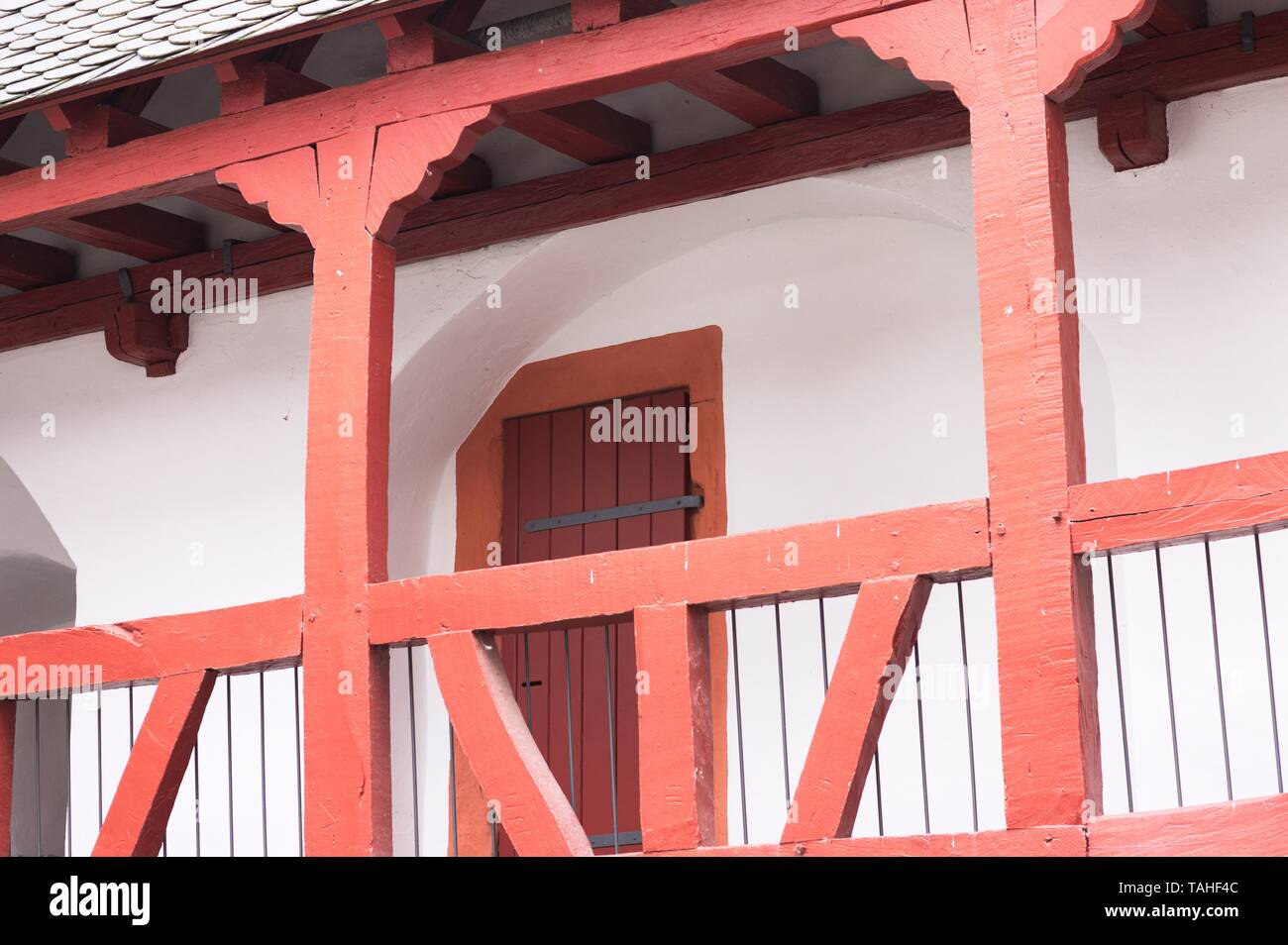 Red railing of an interior balcony with red columns - Medieval ...