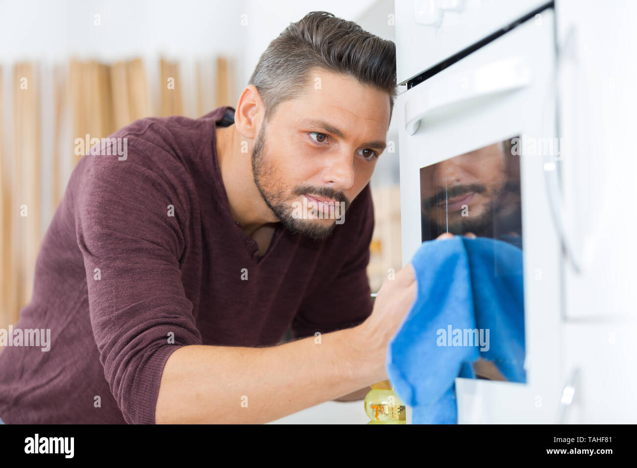 Man cleaning oven in kitchen hi-res stock photography and images - Alamy