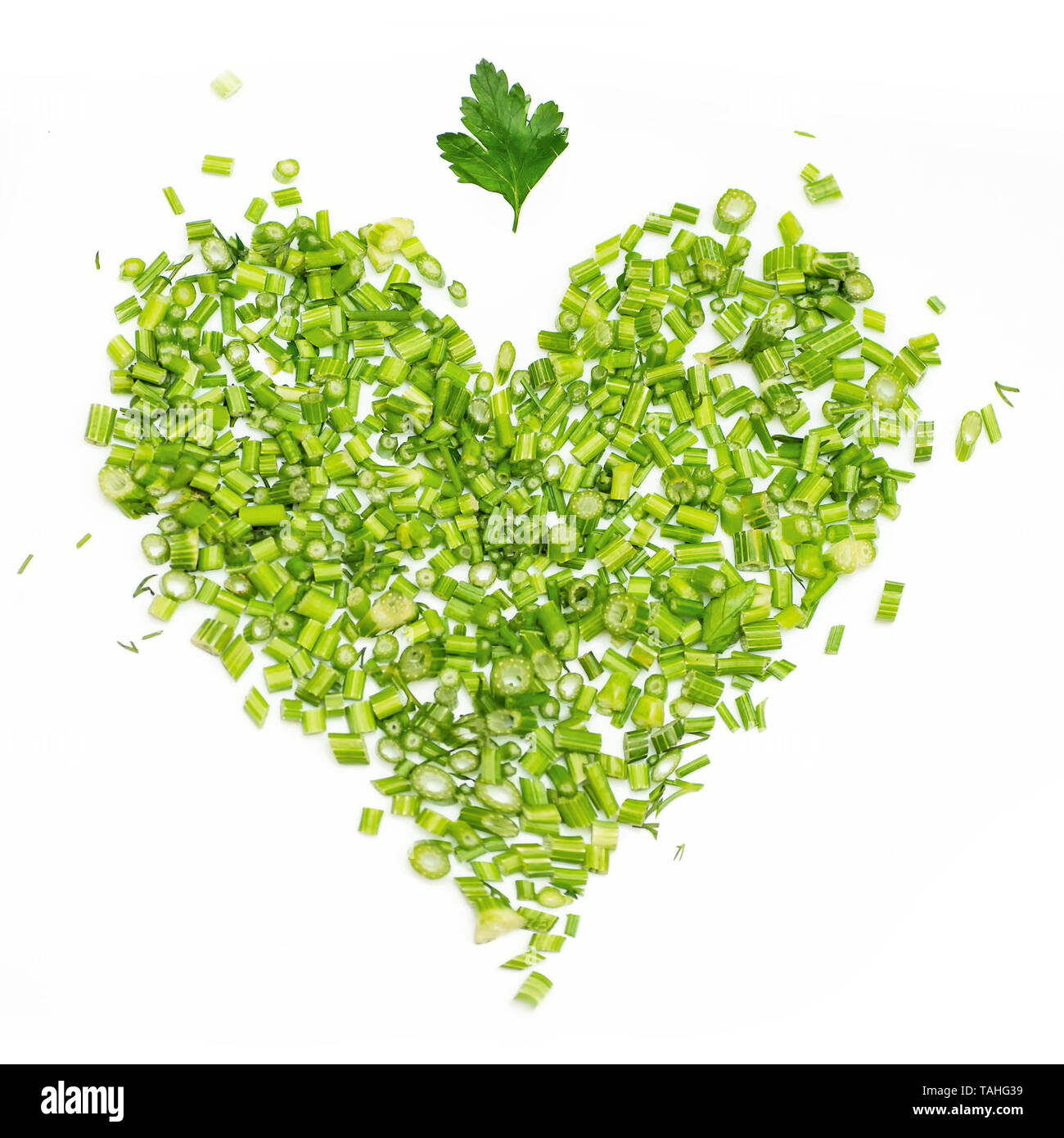 green heart of chopped parsley and dill on white background Stock Photo ...