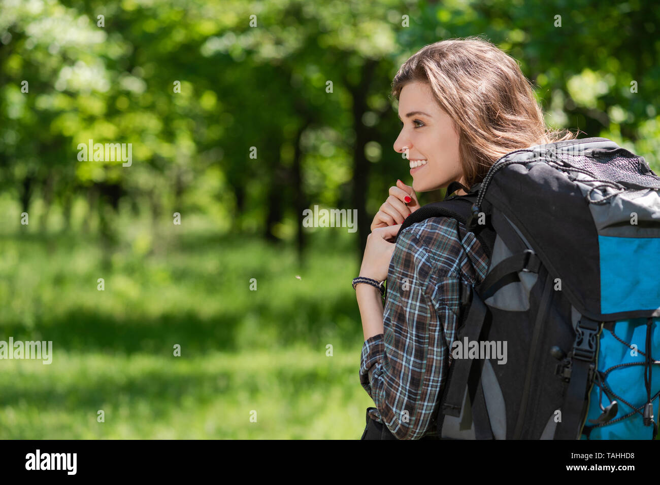 Back view of tourist girl with backpack on forest background Stock ...