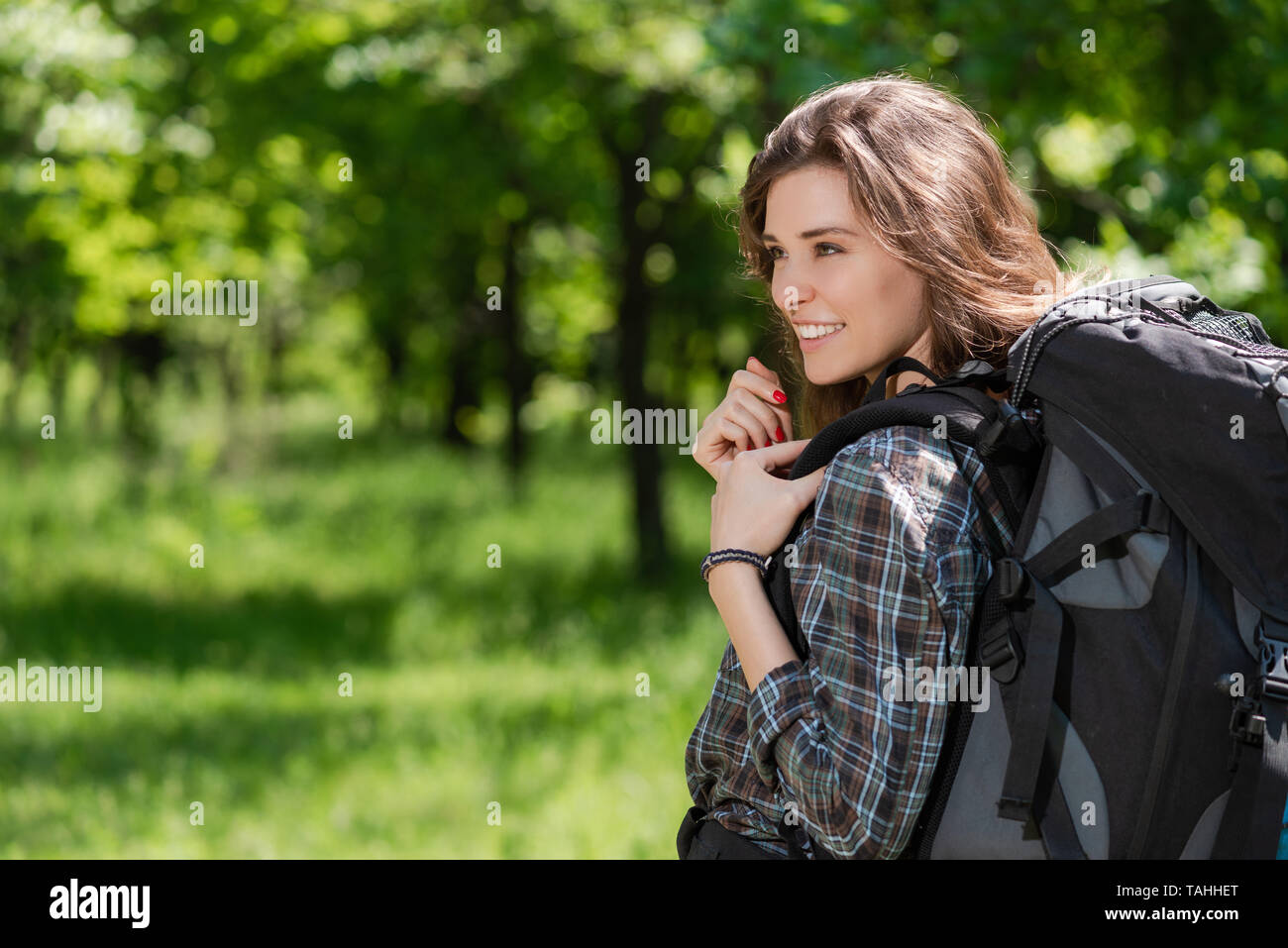 Back view of tourist woman with backpack on forest background Stock ...
