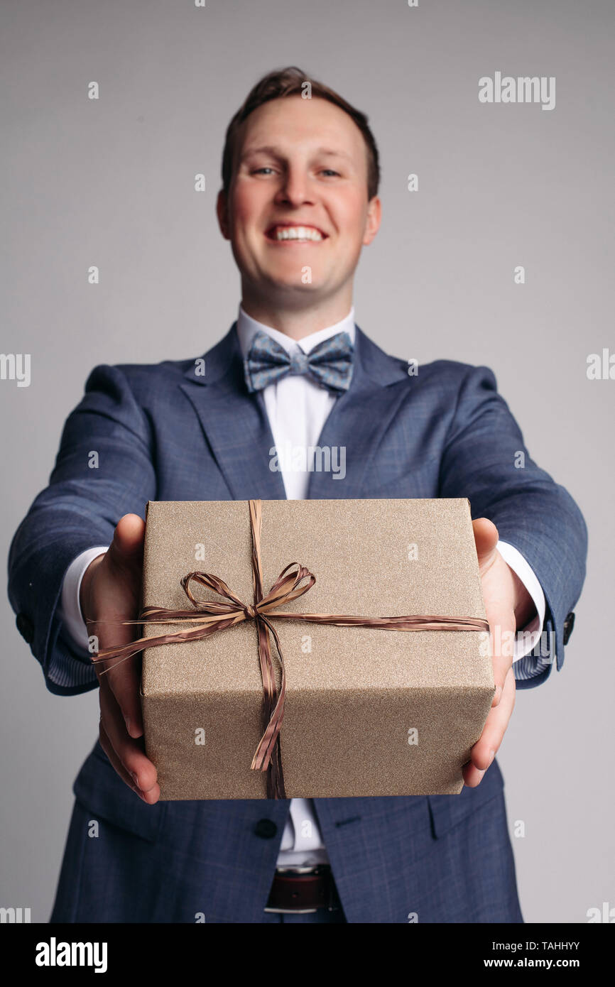 This present is for you Part of man in suit showing present box with ...