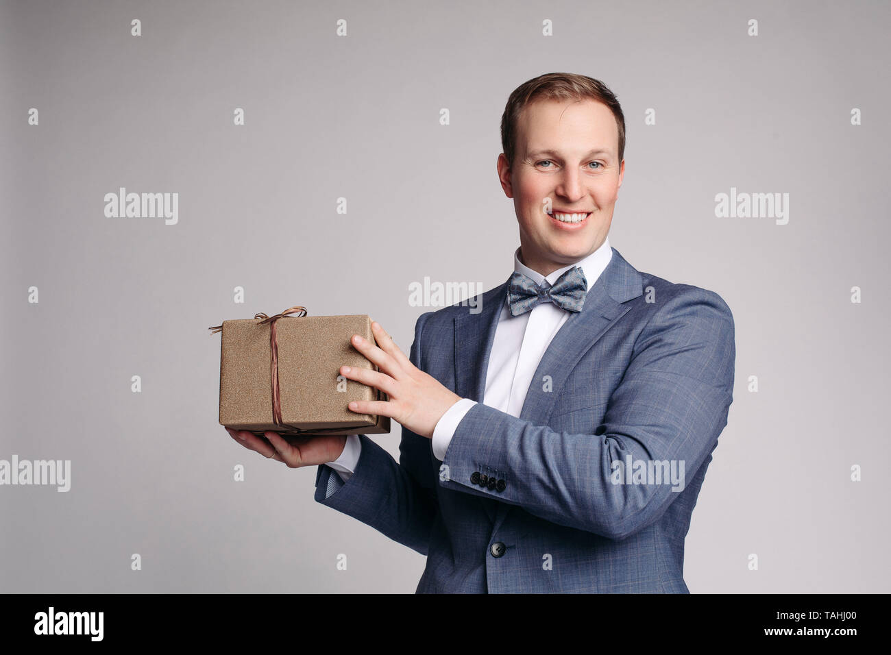 This present is for you Part of man in suit showing present box with ...