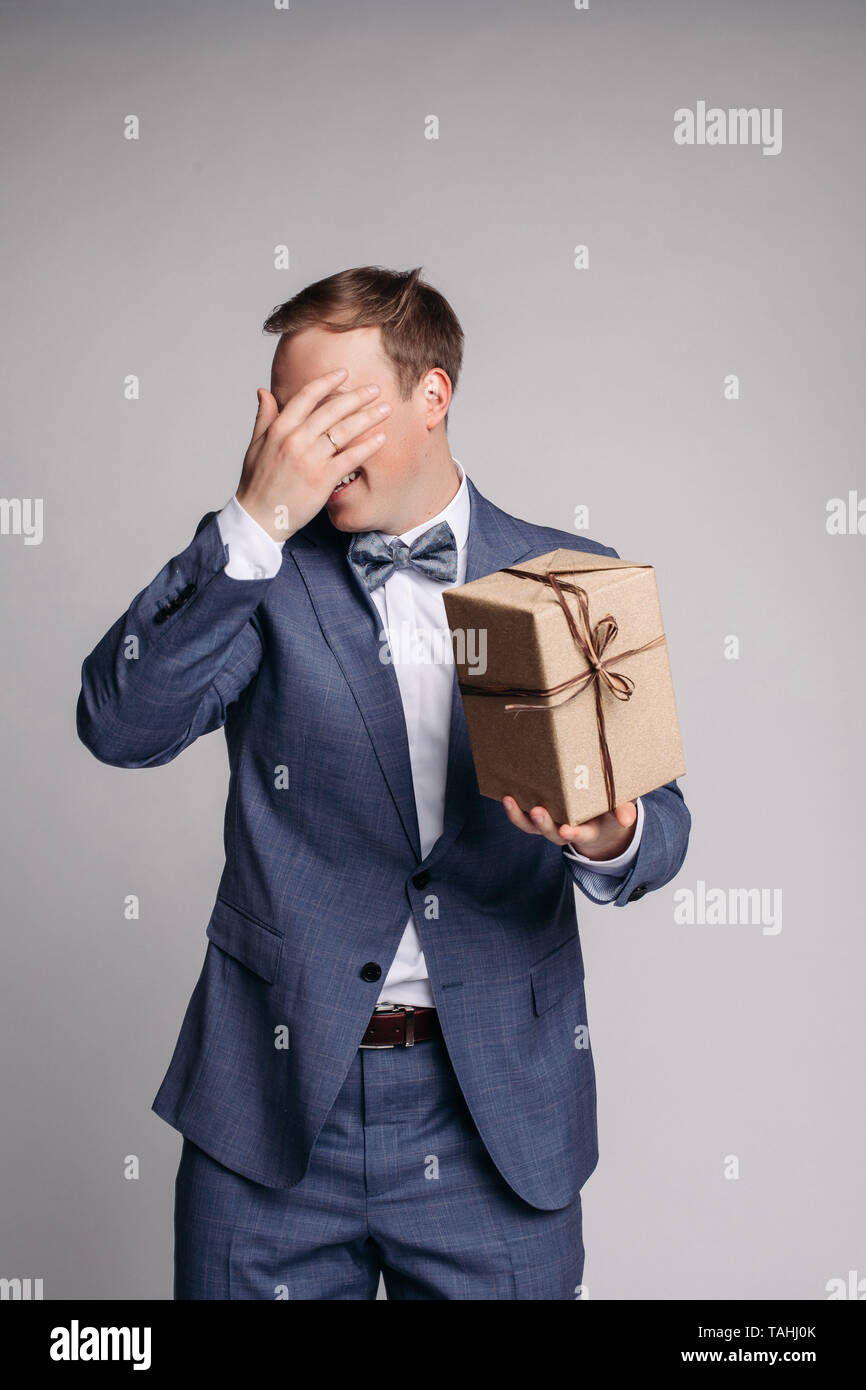 This present is for you Part of man in suit showing present box with ...