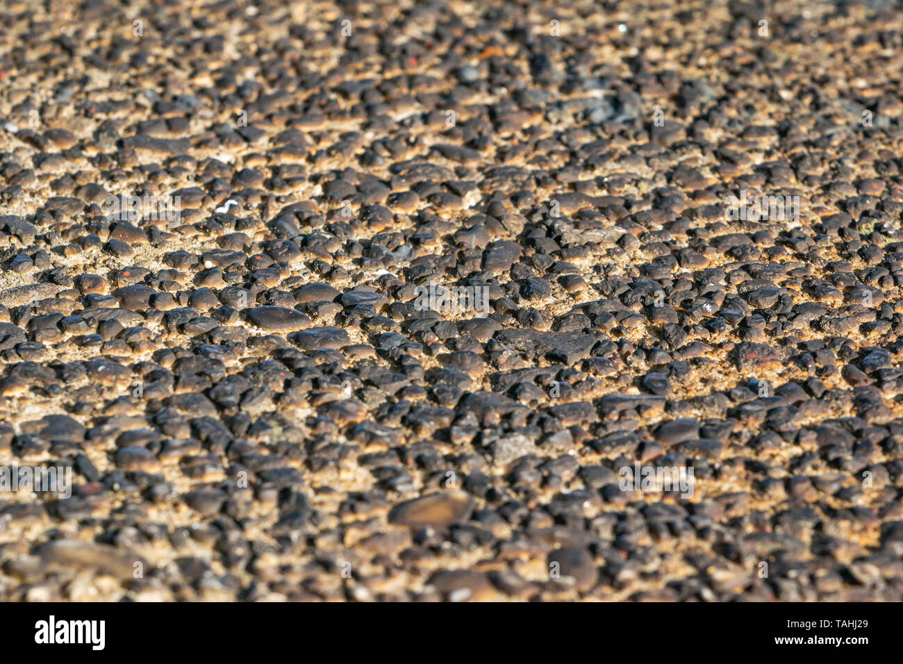 Rough wall texture of small burnt pebbles Stock Photo - Alamy