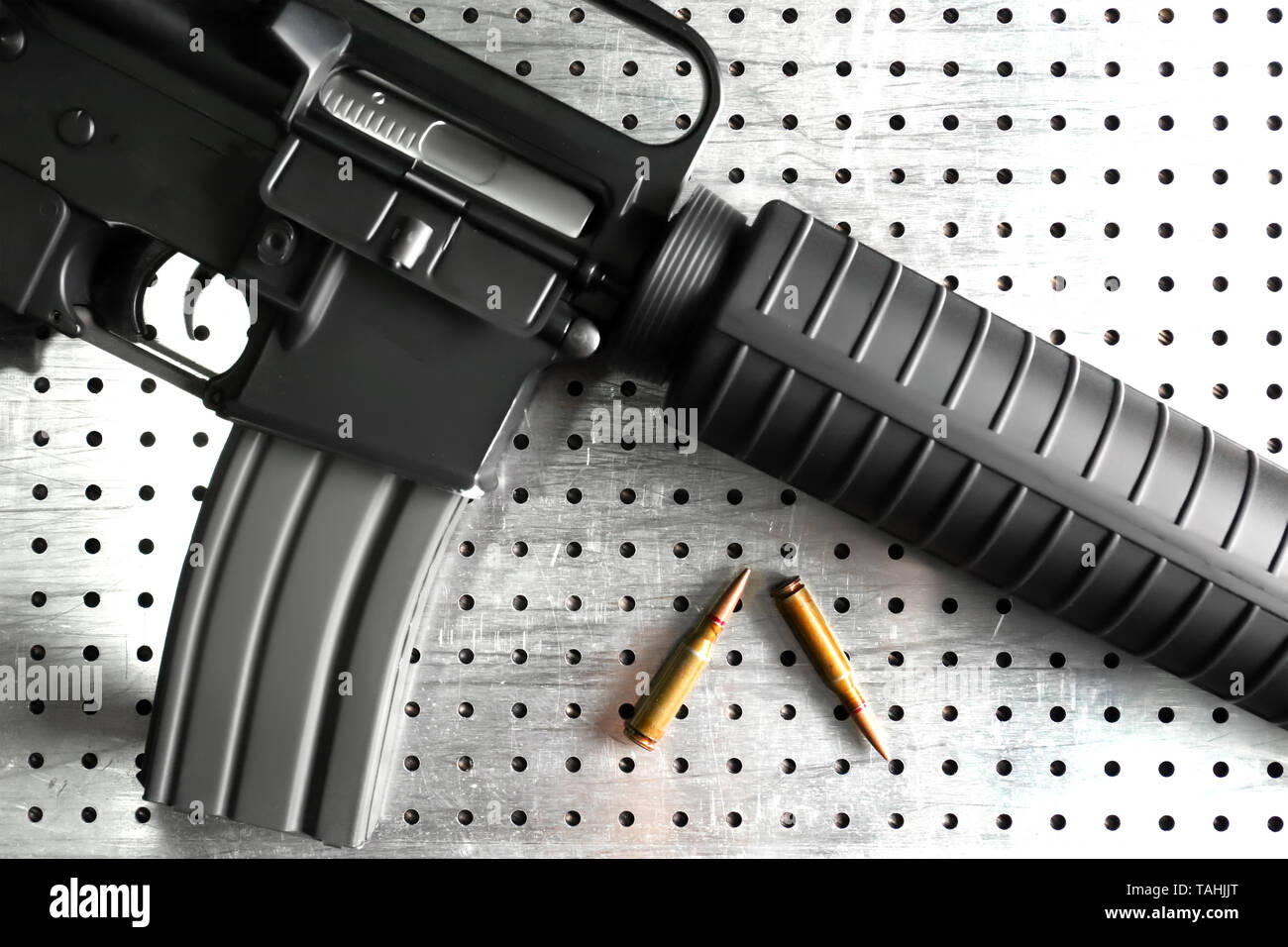 Rifle with bullets on metallic background Stock Photo - Alamy