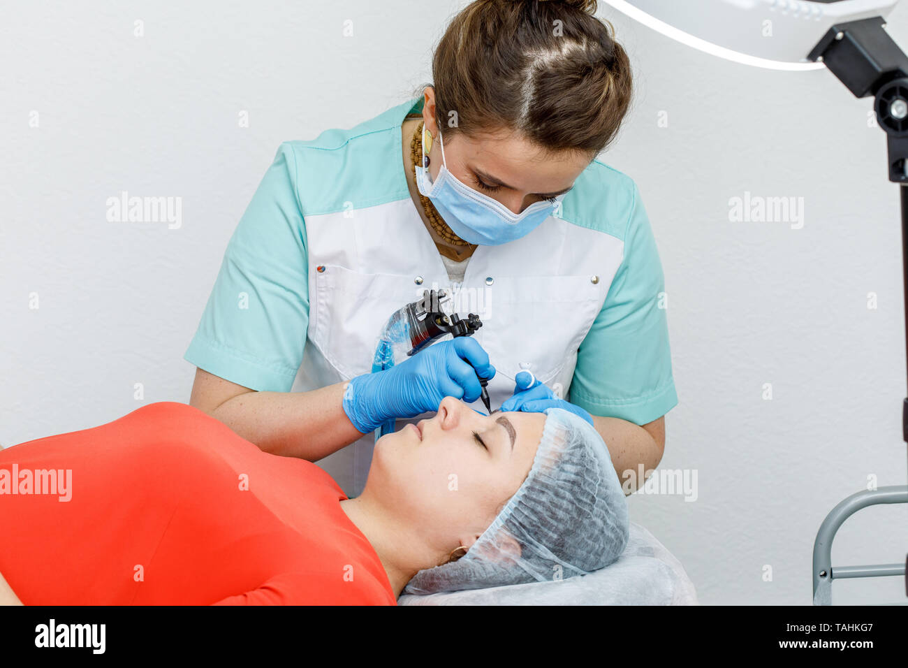 Caucasian female tattooing procedure hi-res stock photography and ...