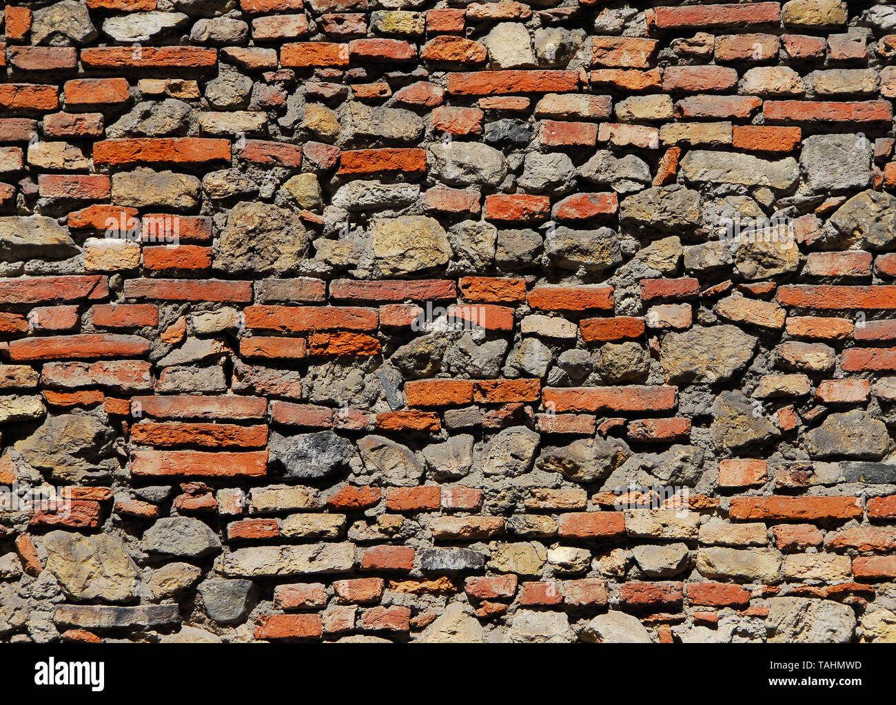 Composite old stone and bricks wall with rough surface as background ...