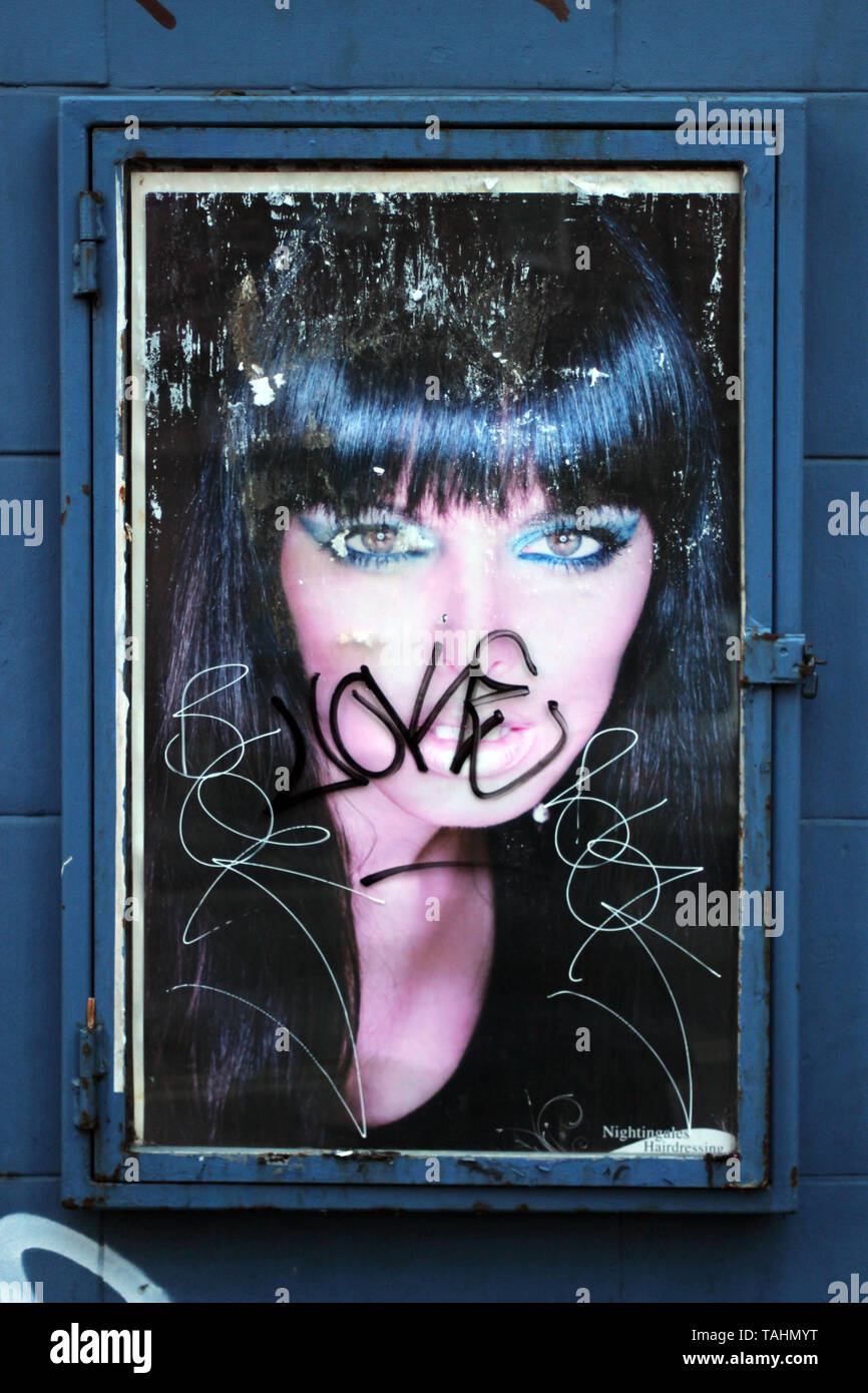 Defaced poster in Soho, London, England Stock Photo - Alamy
