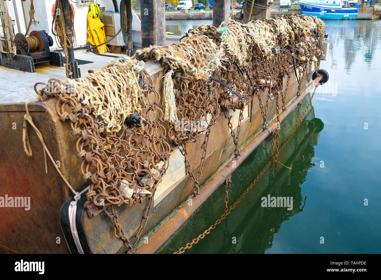 The rear side of a fishing boat in the harbor, showing the nets and ...