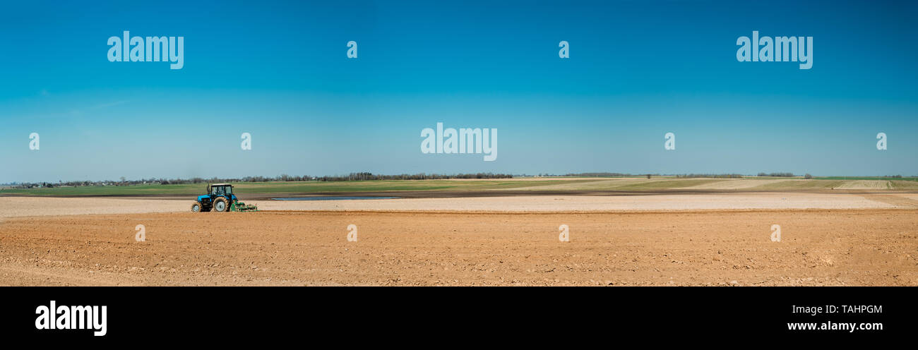 Tractor Plowing Field In Spring Season. Beginning Of Agricultural ...