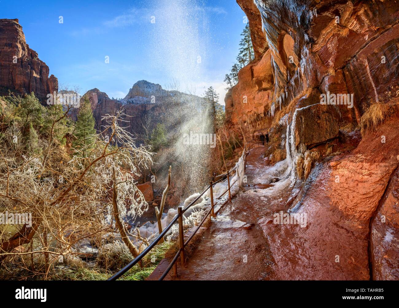 Waterfall falls from overhanging rock in winter, Emerald Pools Trail ...