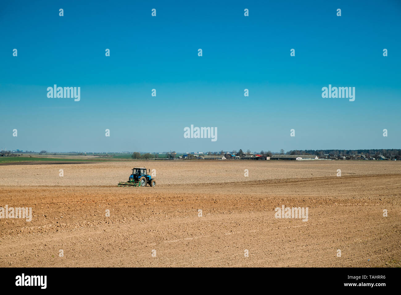 Tractor Plowing Field In Spring Season. Beginning Of Agricultural ...