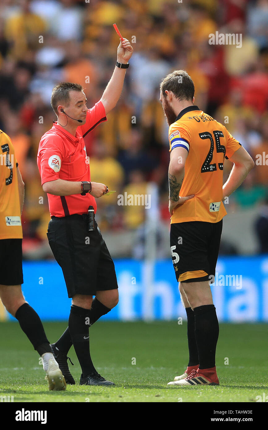 Match referee Ross Joyce shows a red card to Newport County's Mark O ...