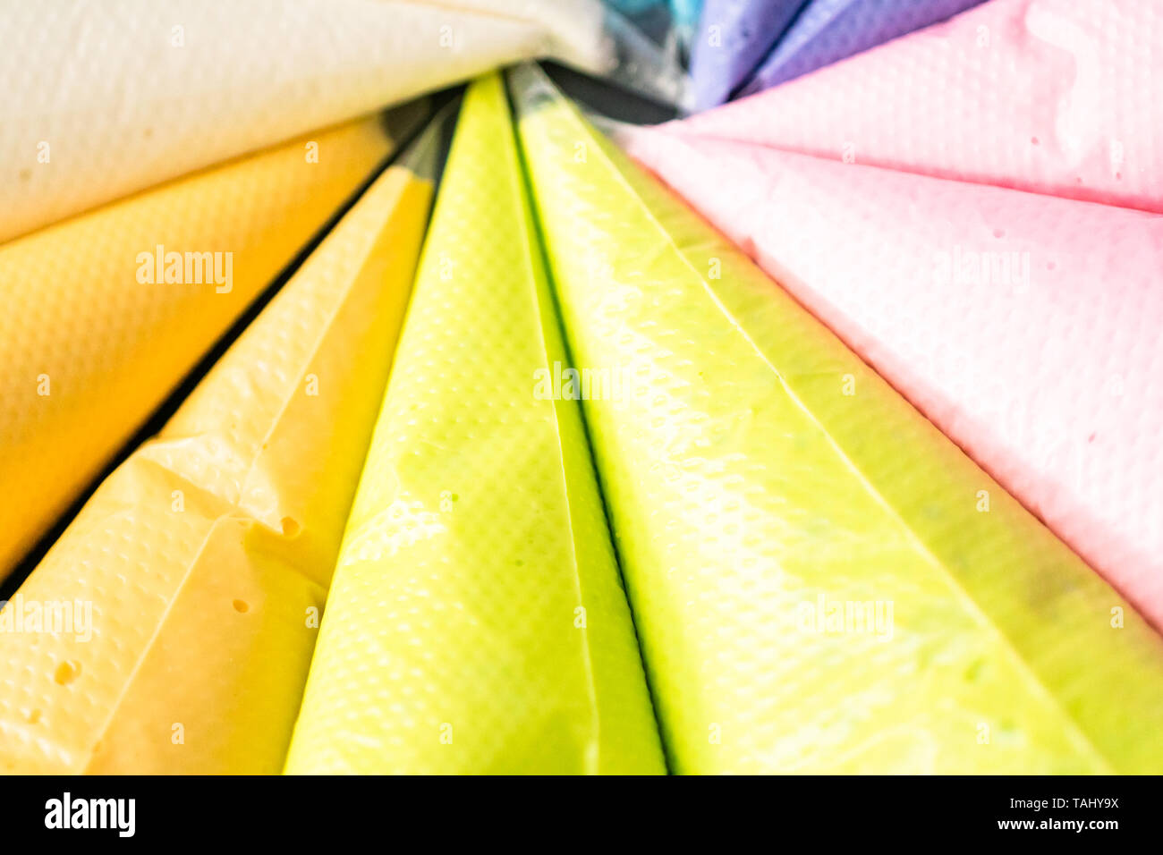 Variety of colors of royal icing in plastic piping bags Stock Photo - Alamy
