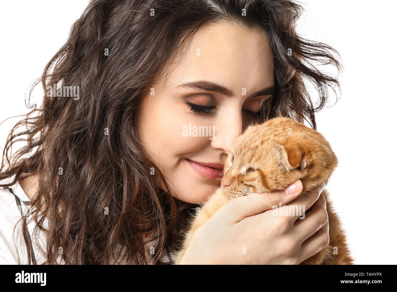 Young woman with her cute funny cat on white background Stock Photo - Alamy