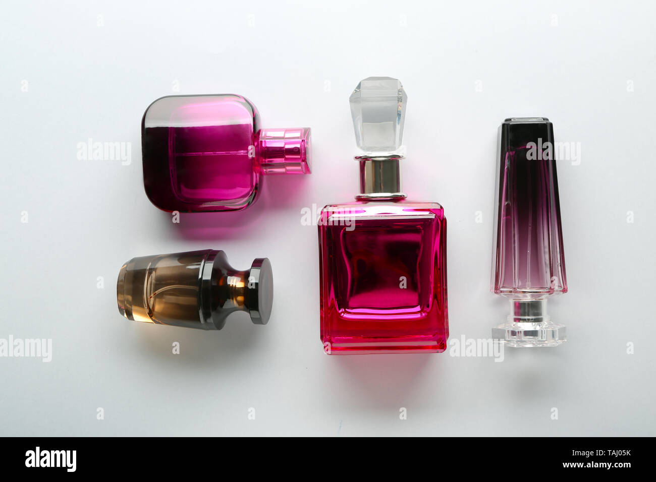 Bottles of perfume on light background Stock Photo - Alamy