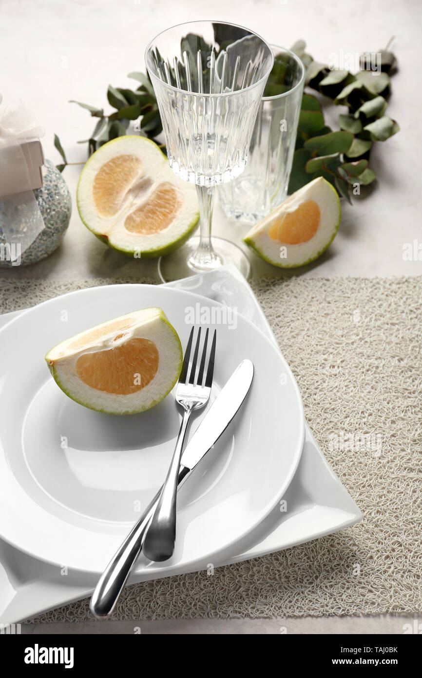 Beautiful table setting with citrus fruit Stock Photo - Alamy