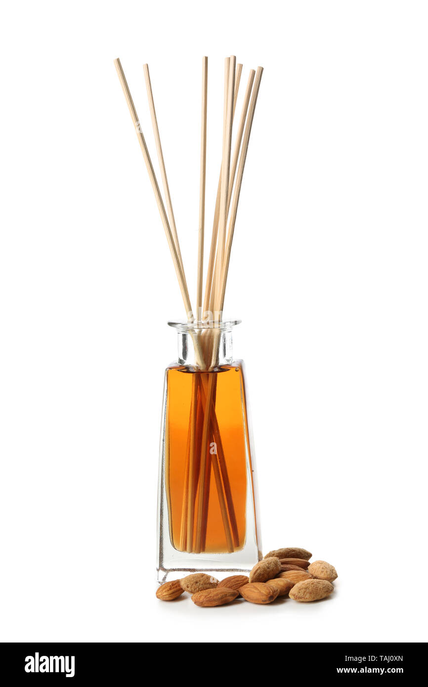 Reed diffuser and almonds on white background Stock Photo - Alamy