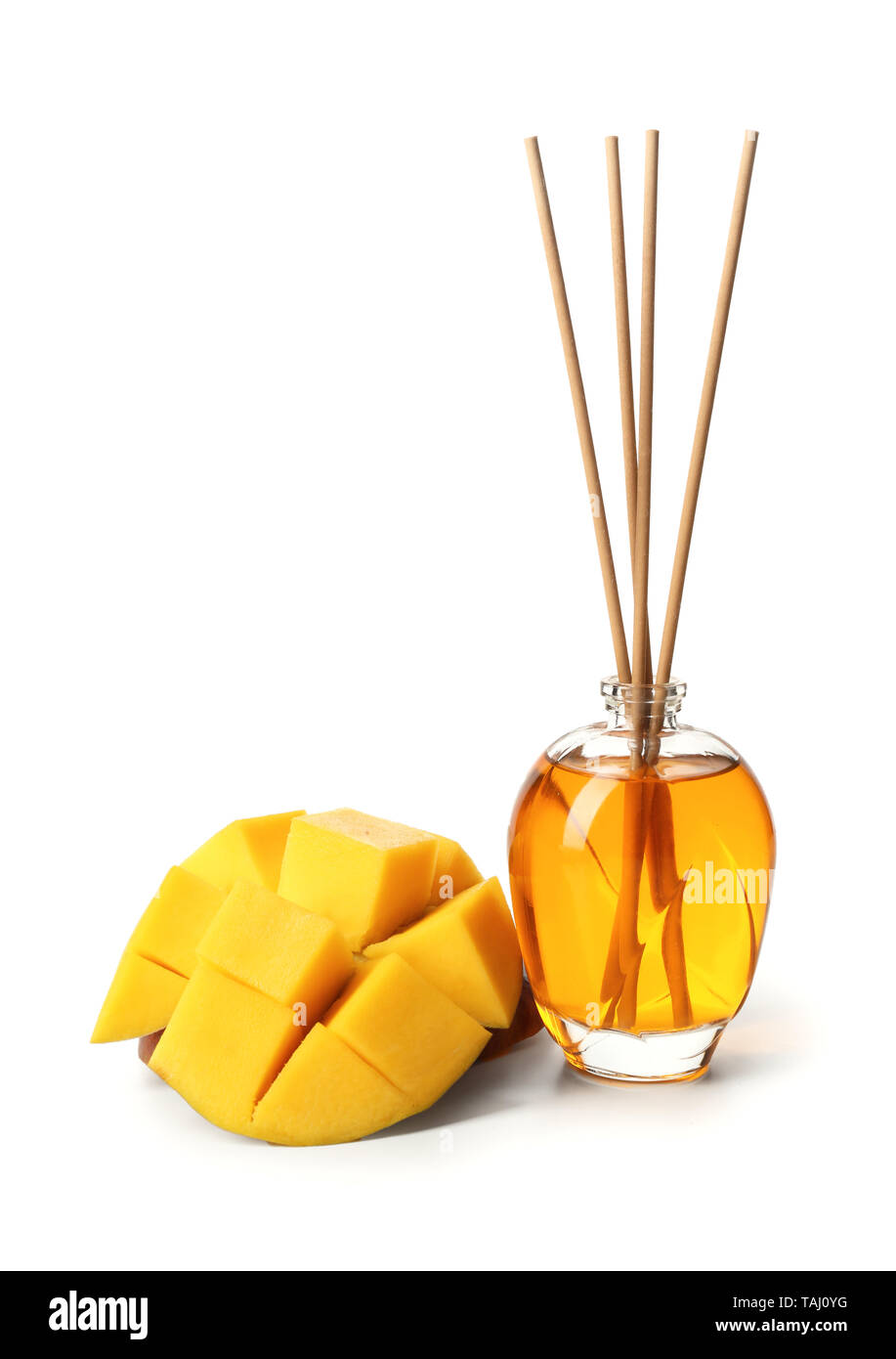 Reed diffuser and mango on white background Stock Photo - Alamy