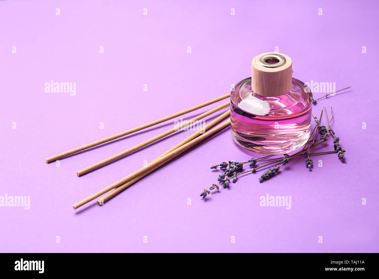 Reed diffuser on color background Stock Photo - Alamy