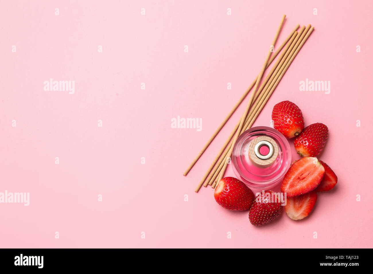 Strawberry reed diffuser on color background Stock Photo - Alamy
