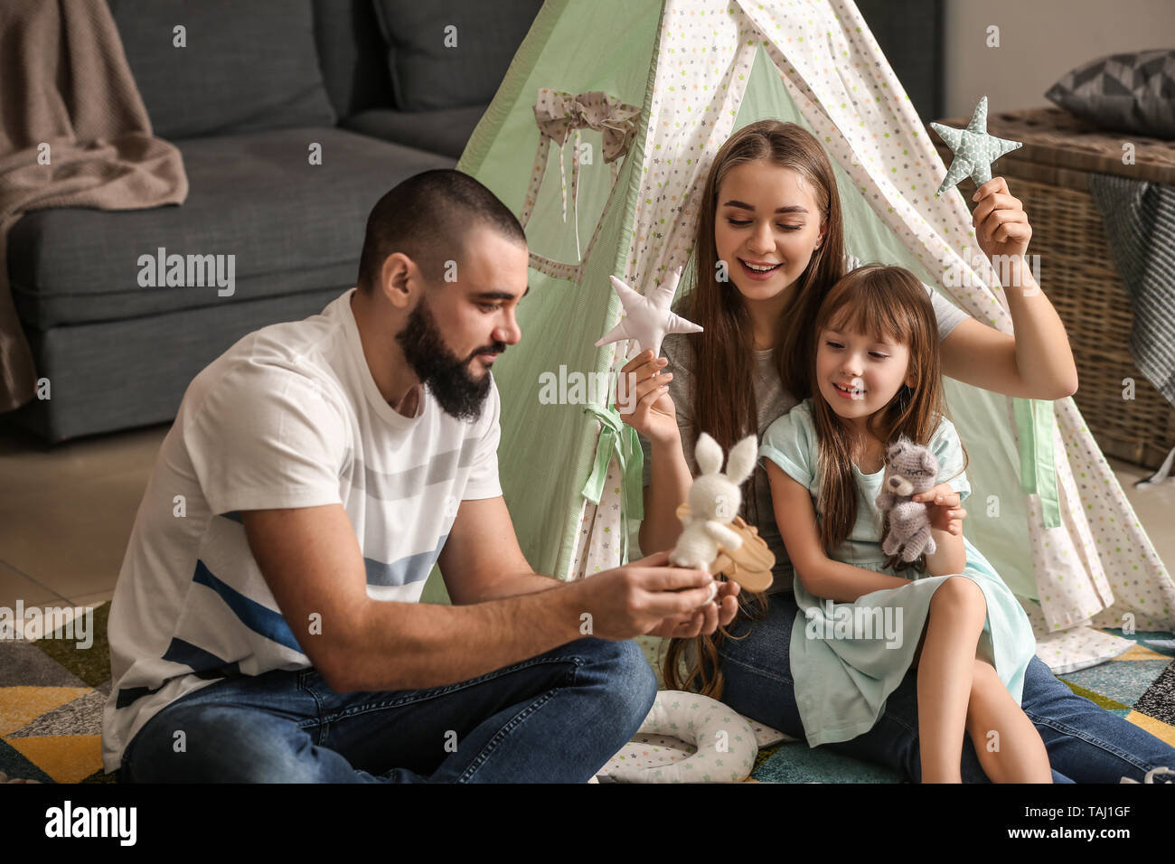Happy family playing at home Stock Photo - Alamy