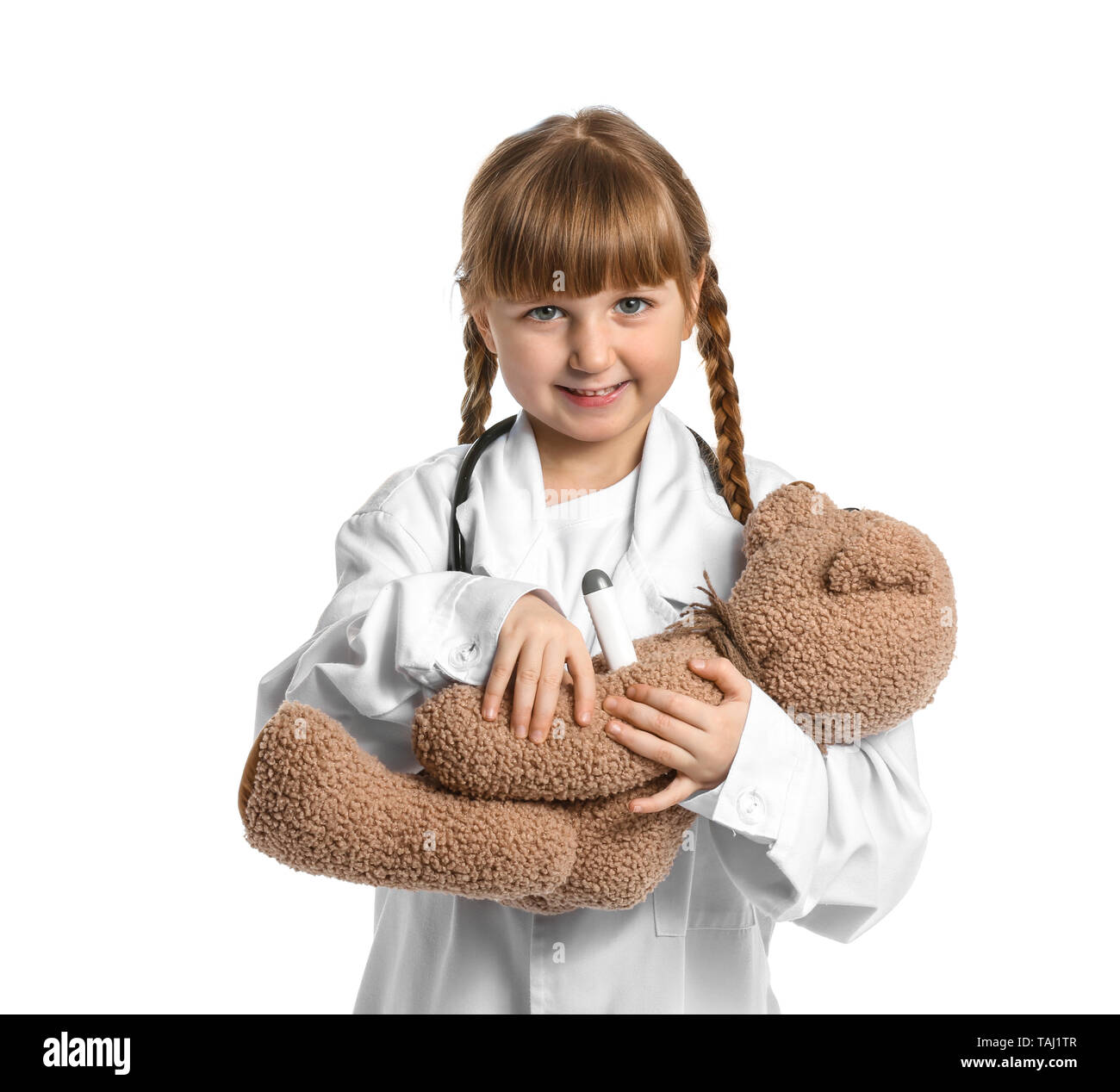 Portrait of cute little doctor with teddy bear on white background ...