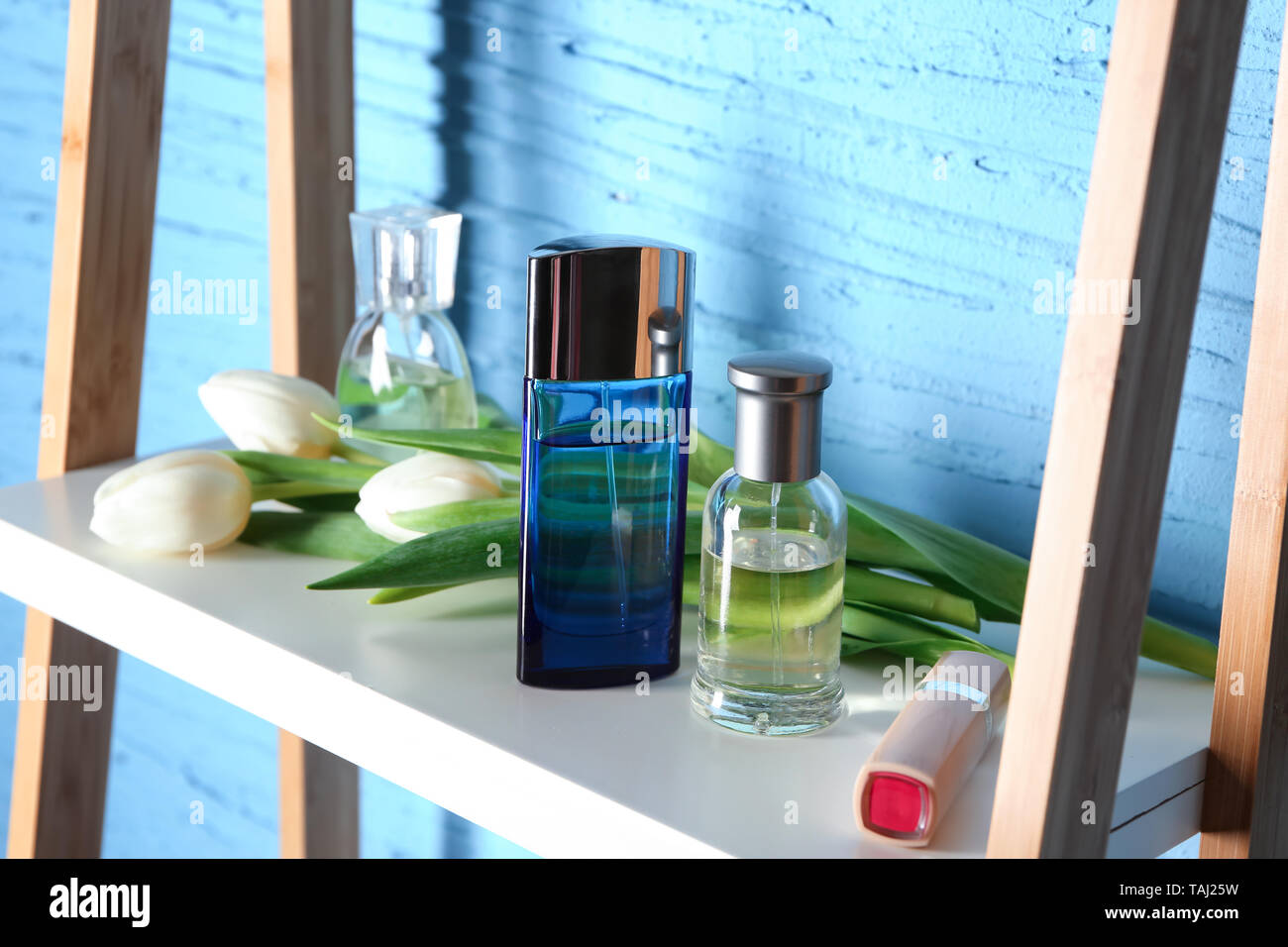 Bottles of perfume and flowers on shelf Stock Photo - Alamy