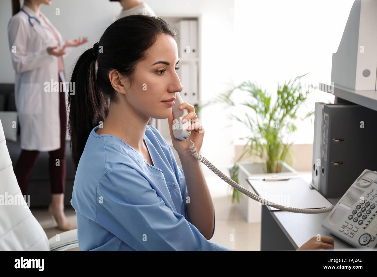 Medical receptionist phone hi-res stock photography and images - Alamy
