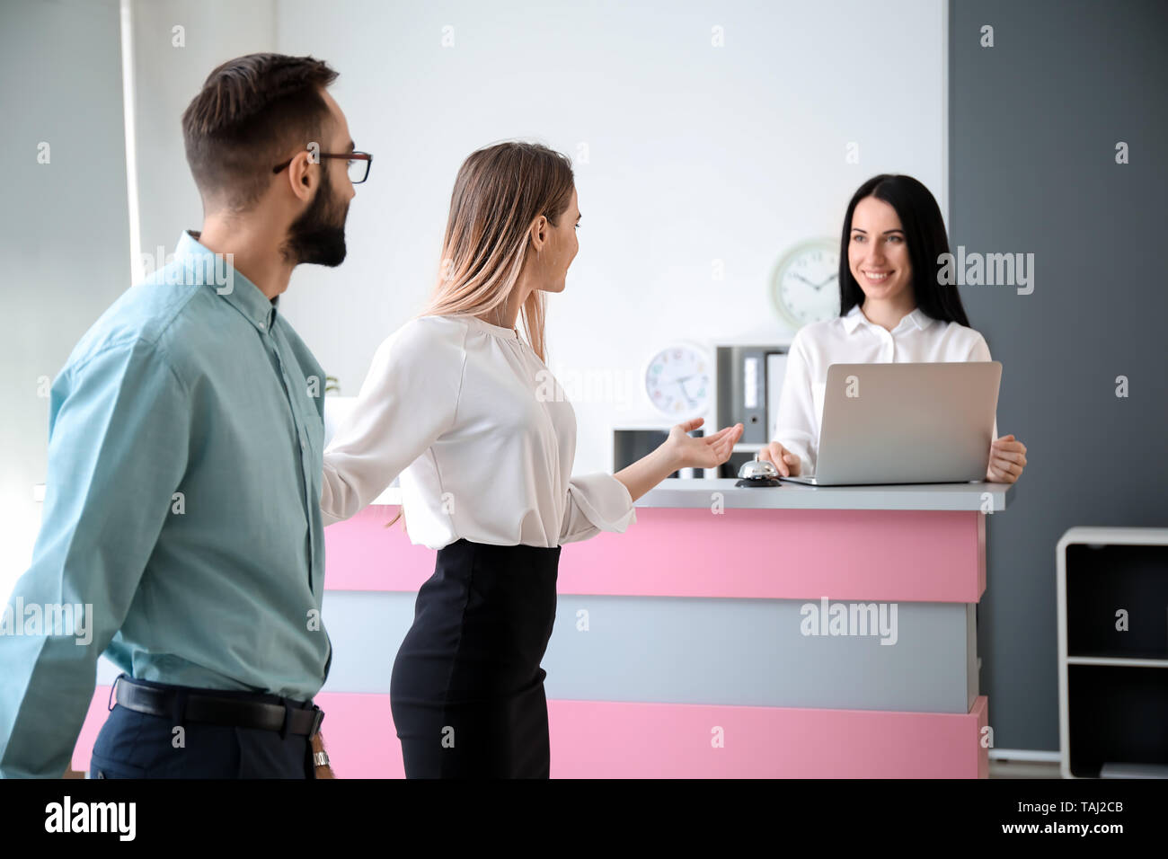 Young man at reception desk in hotel Stock Photo - Alamy